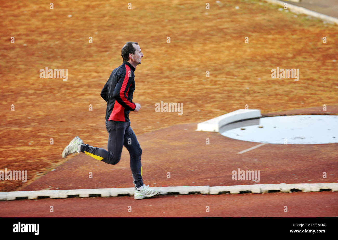 adult man running on athletics track Stock Photo - Alamy
