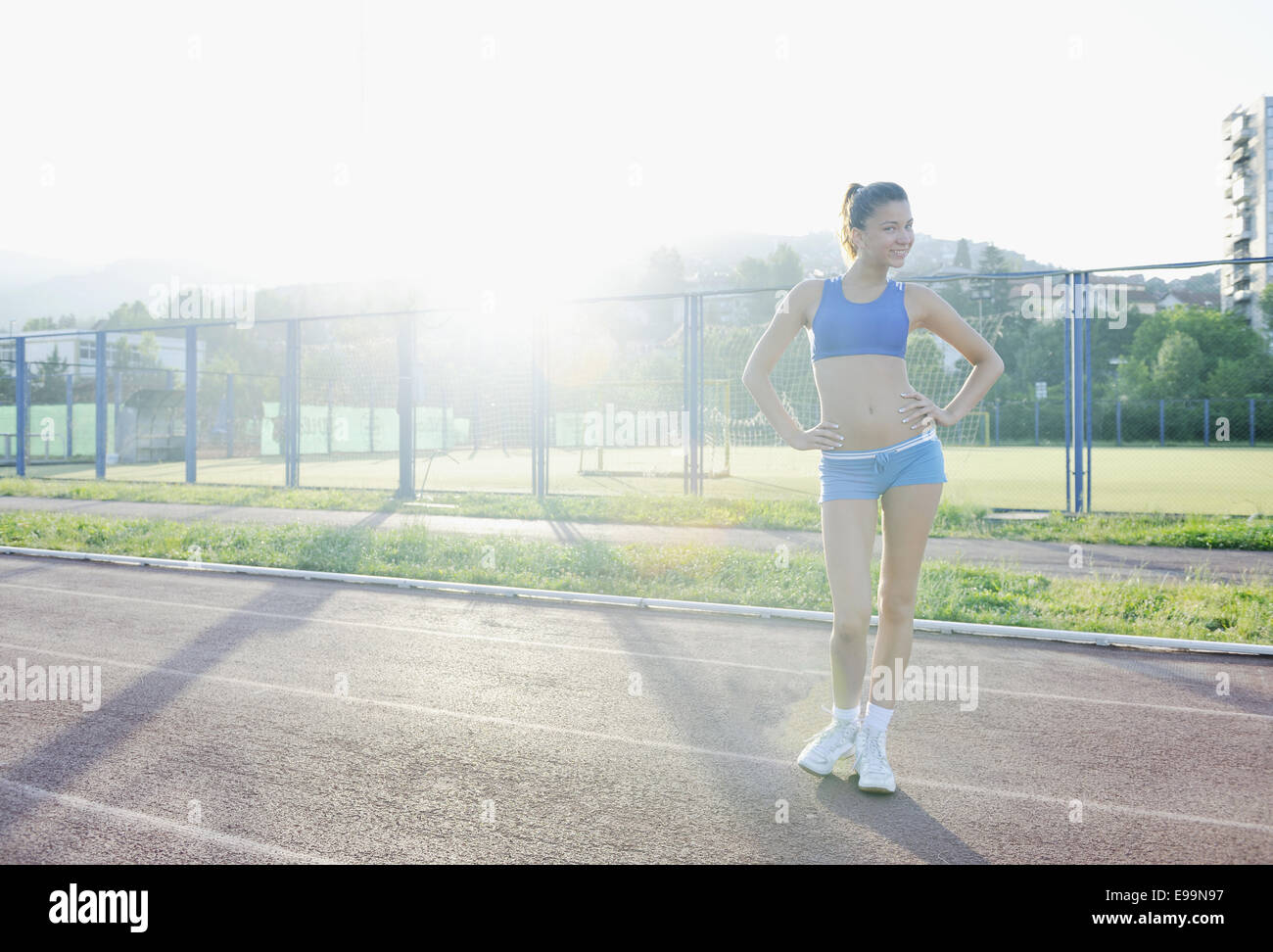 happy young woman on athletic race track Stock Photo - Alamy