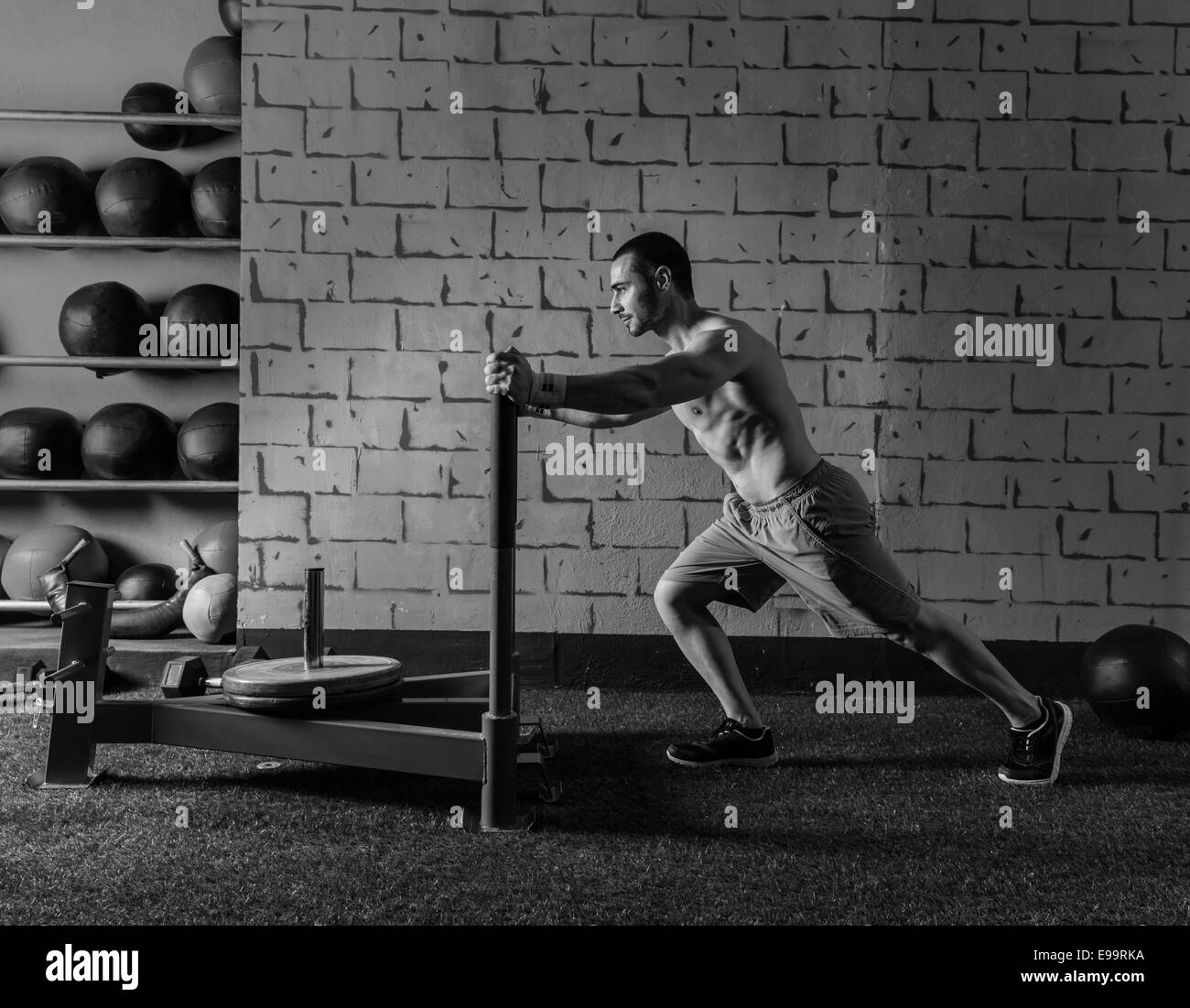 sled push man pushing weights workout exercise Stock Photo - Alamy