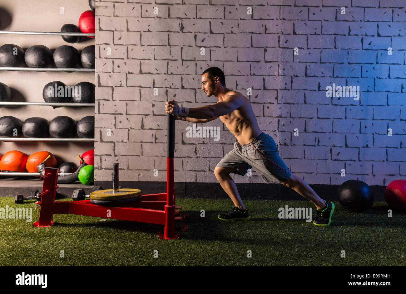 sled push man pushing weights workout exercise Stock Photo - Alamy