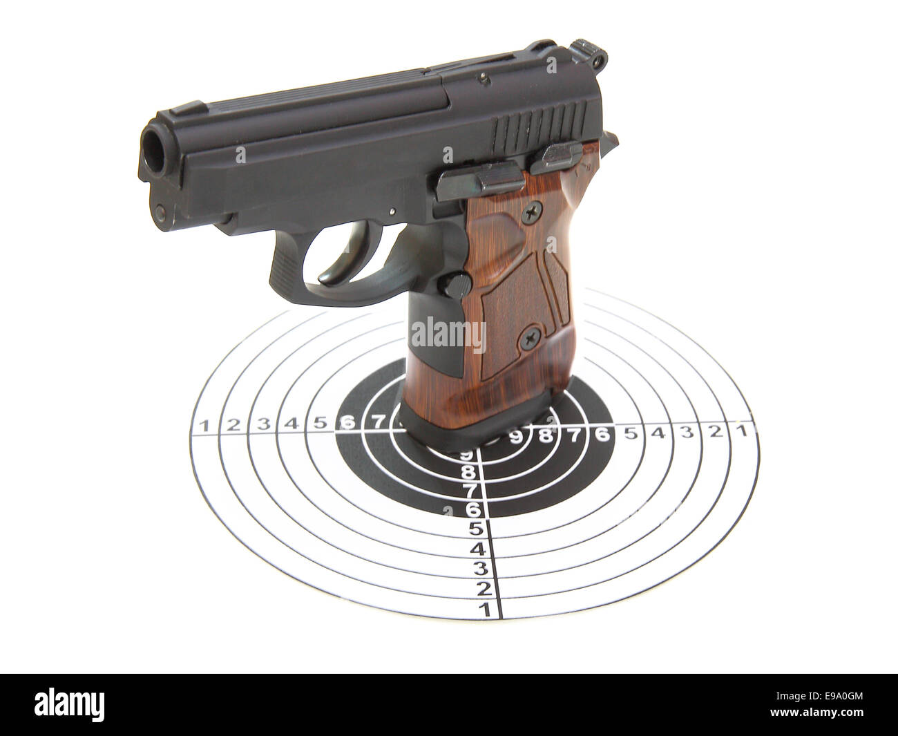 The pistol with the brown handle Stock Photo - Alamy