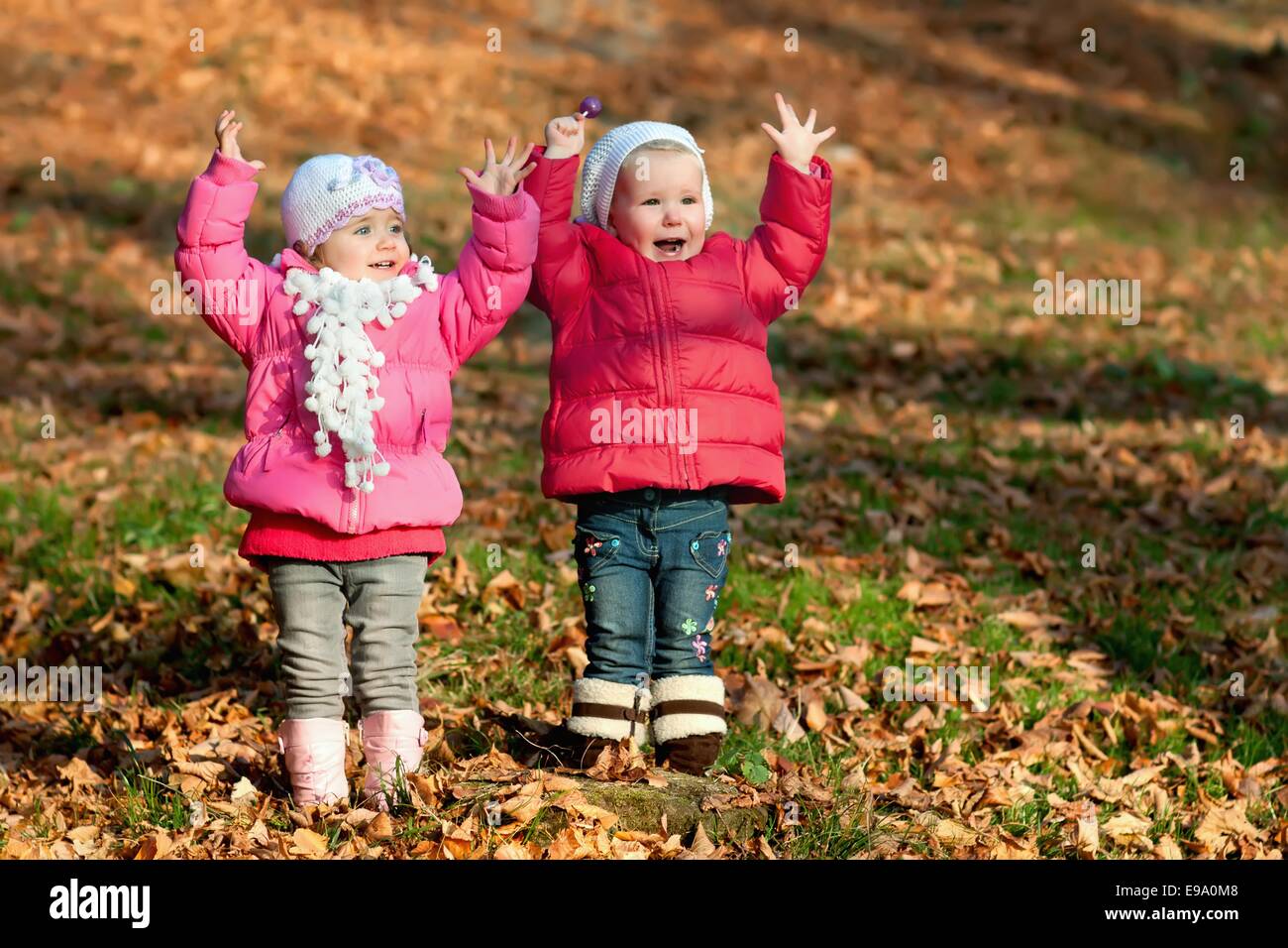 Two happy girls in park on autumn Stock Photo - Alamy