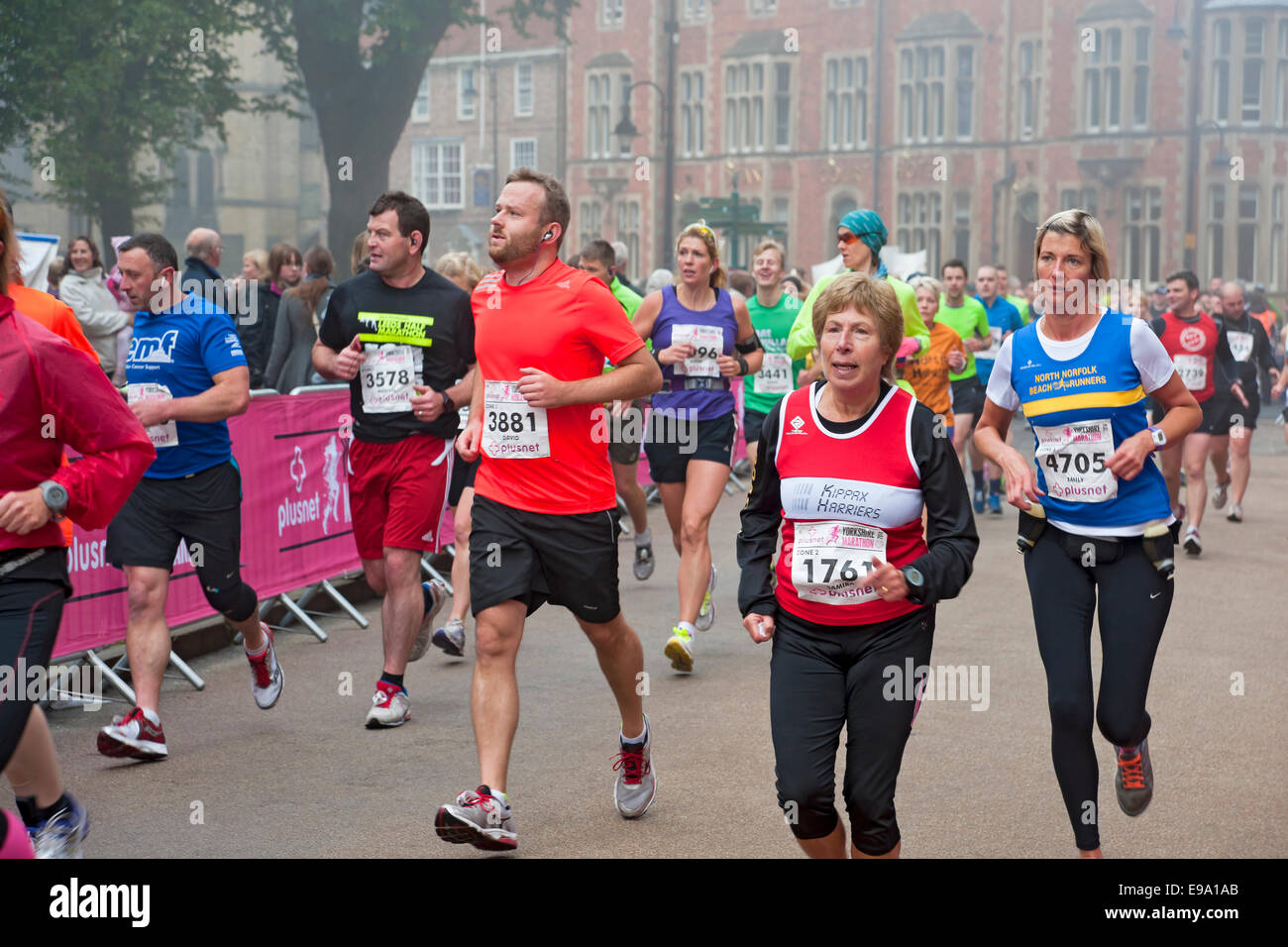 People runners men and women running through the city centre in the ...