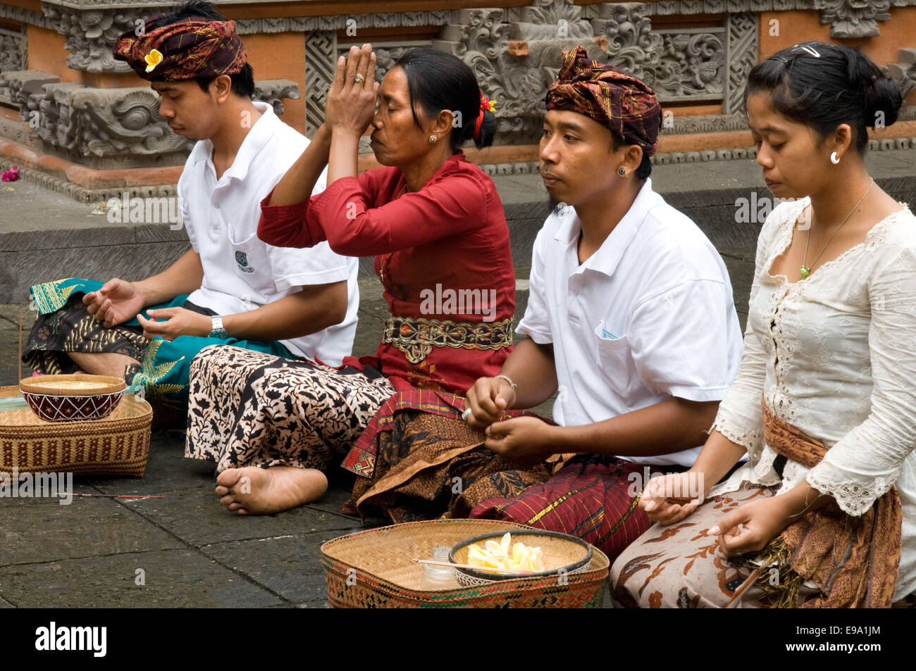 Several people pray and leave offerings in the Holy Monkey Forest ...
