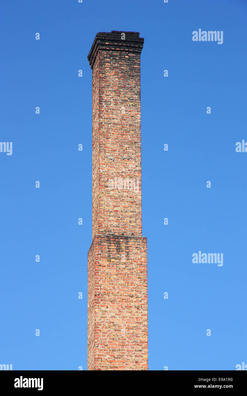 one orange brick pipe on blue sky Stock Photo - Alamy