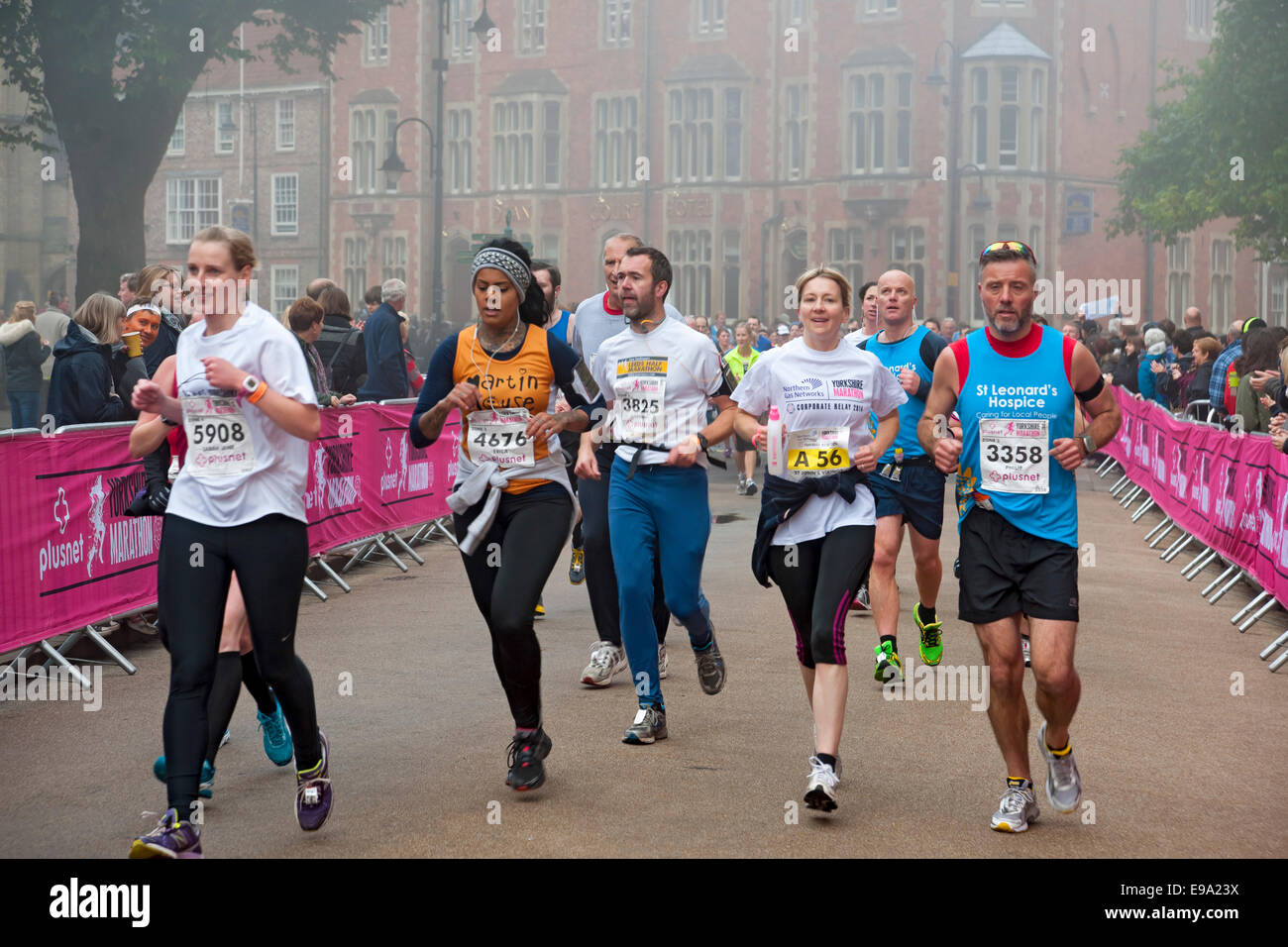 Competitors runners men and women running through the city centre in ...
