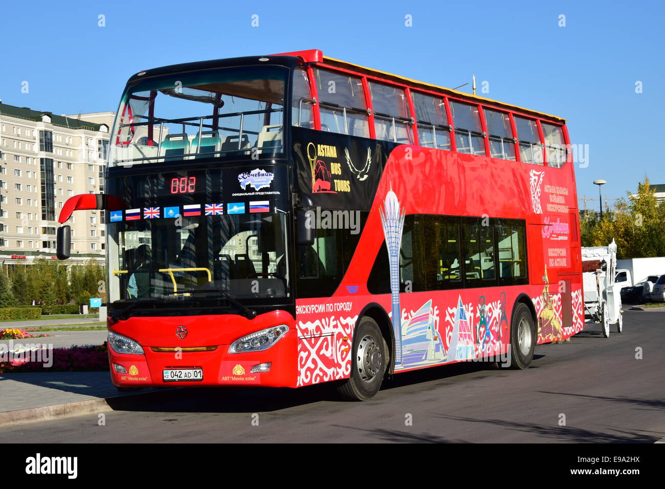A double-decker bus ASTANA CITY TOURS near the BAITEREK tower in Astana ...