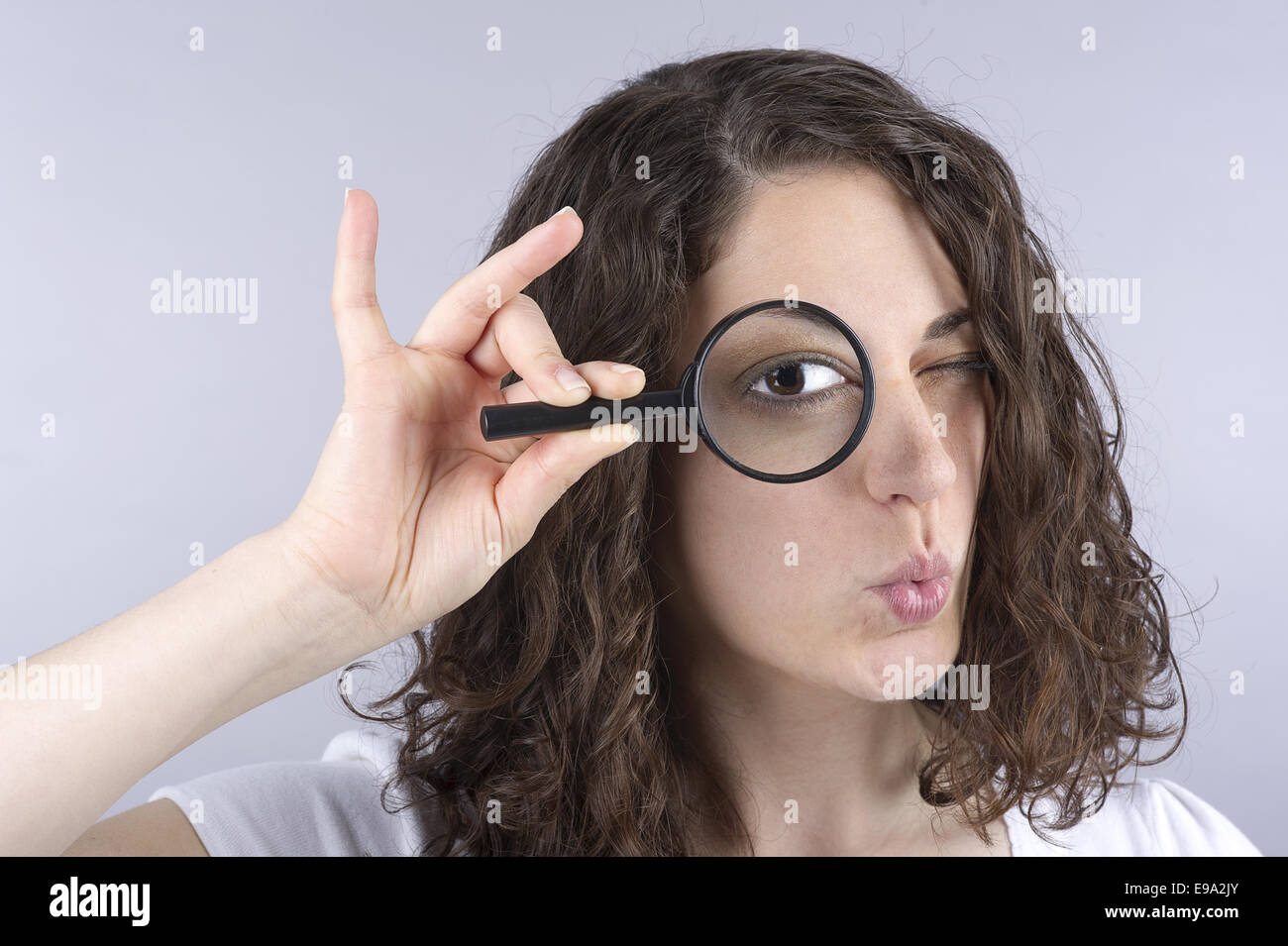 Woman with magnifying glass Stock Photo - Alamy