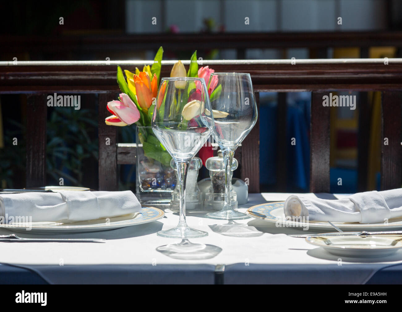 Table setting exterior restaurant in sunshine Stock Photo - Alamy