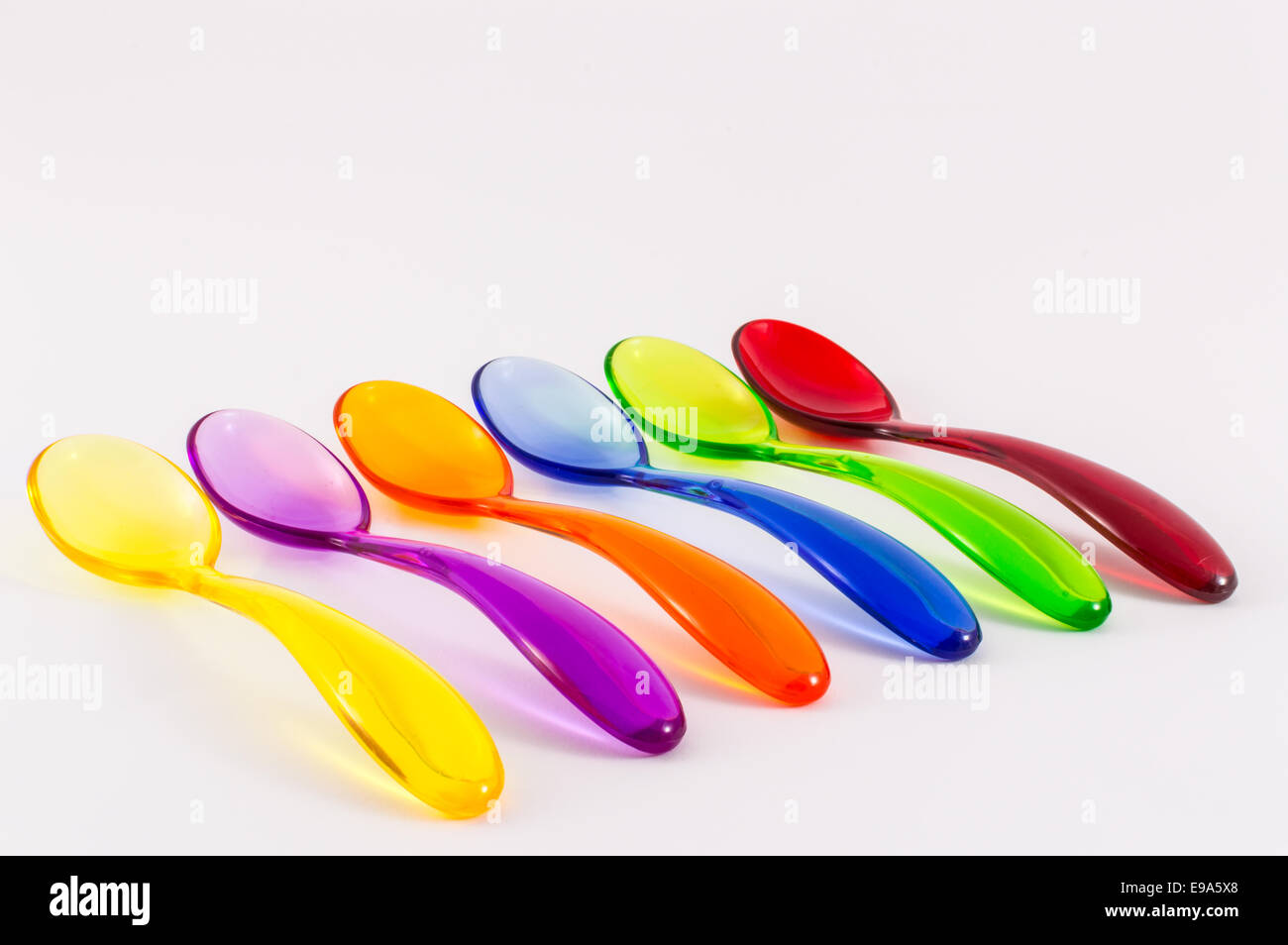Colorful plastic spoons on white background Stock Photo - Alamy