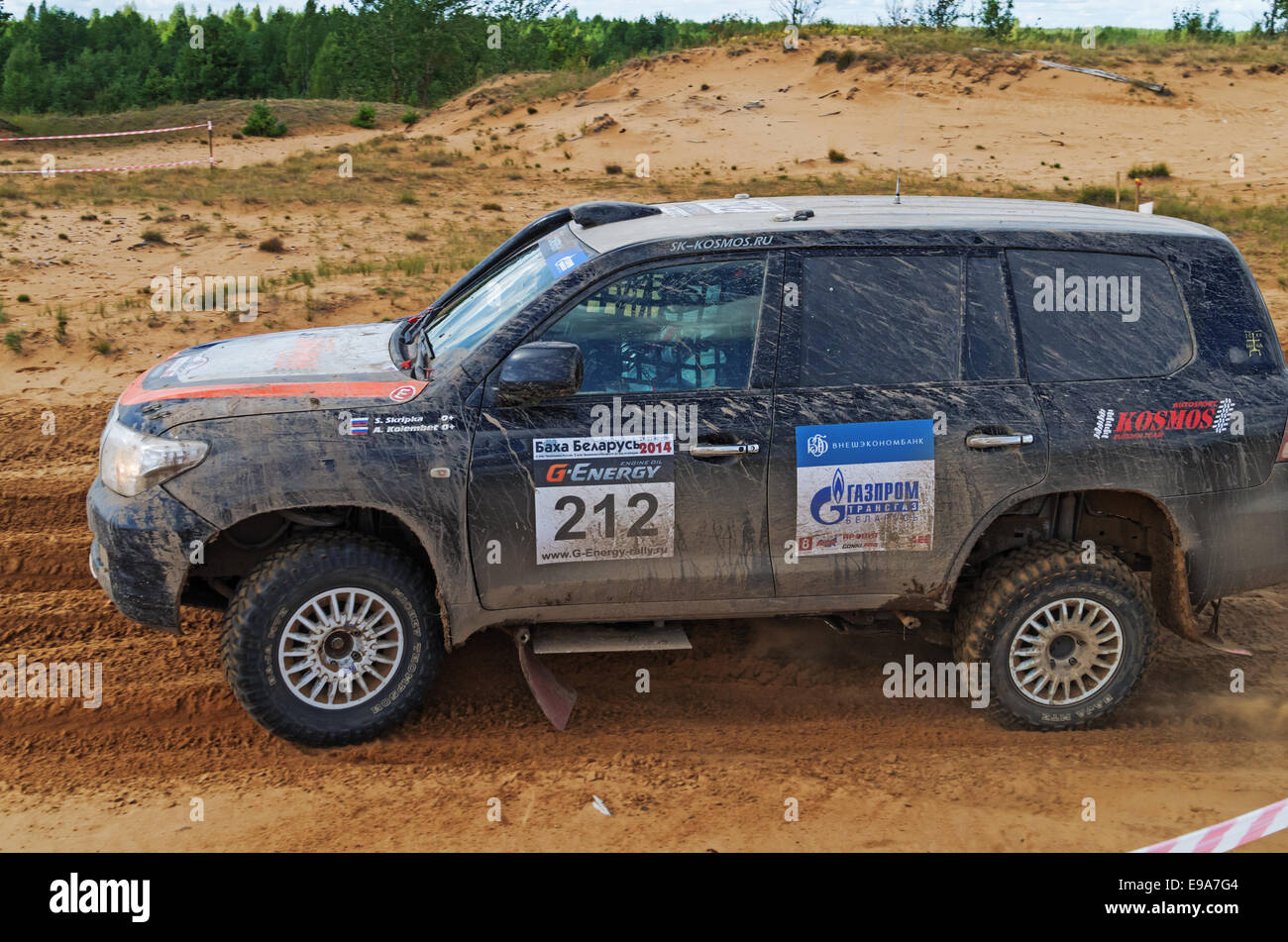 Races on a rally-raid on sandy dunes. Racing car number 212 Stock Photo ...