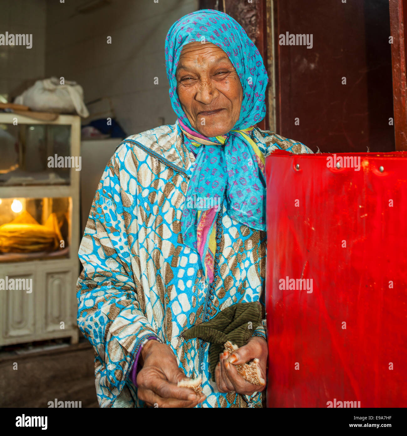 Smiling elderly lady with bread in Morocco Stock Photo - Alamy