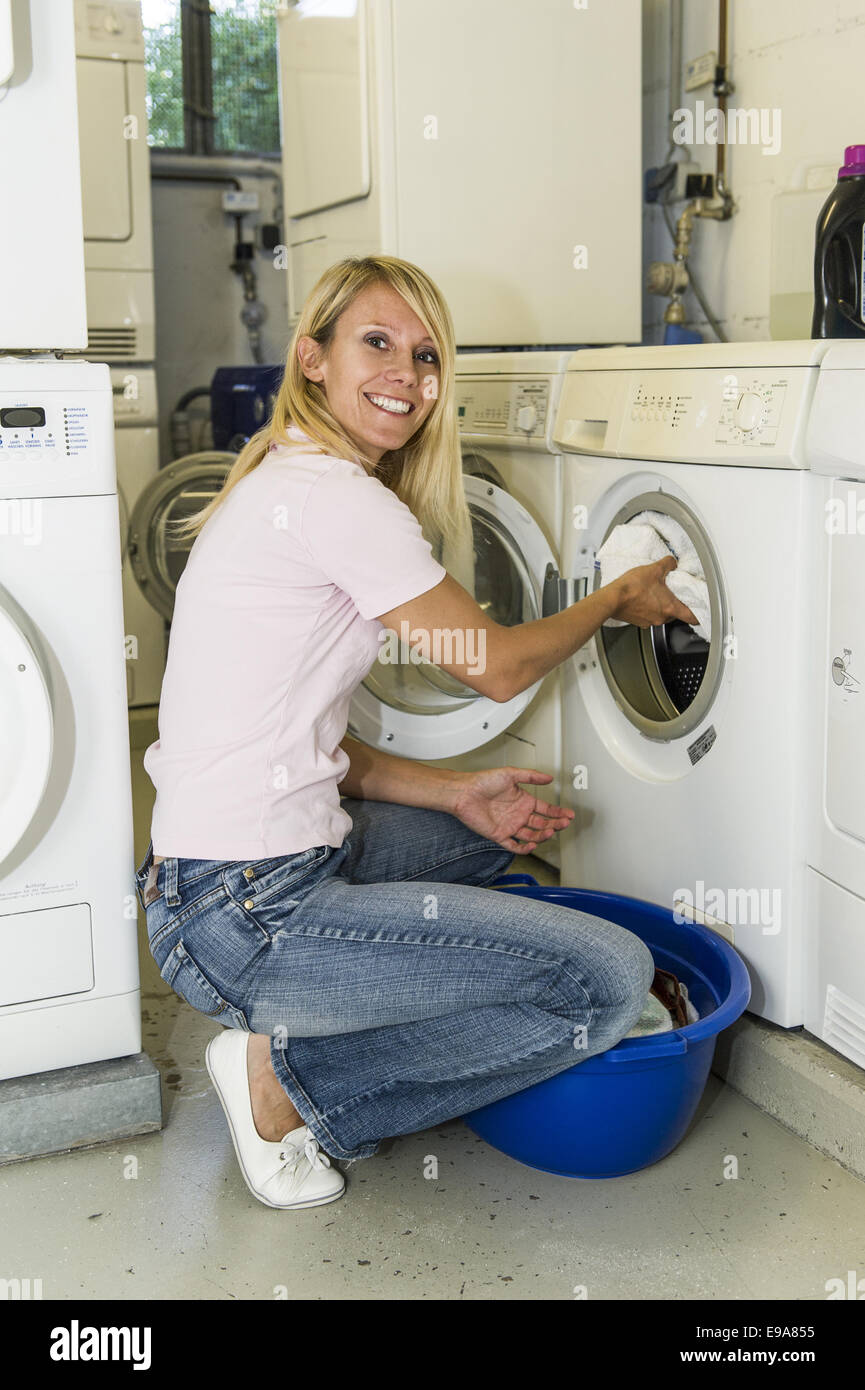 Woman filled a washing machine Stock Photo - Alamy