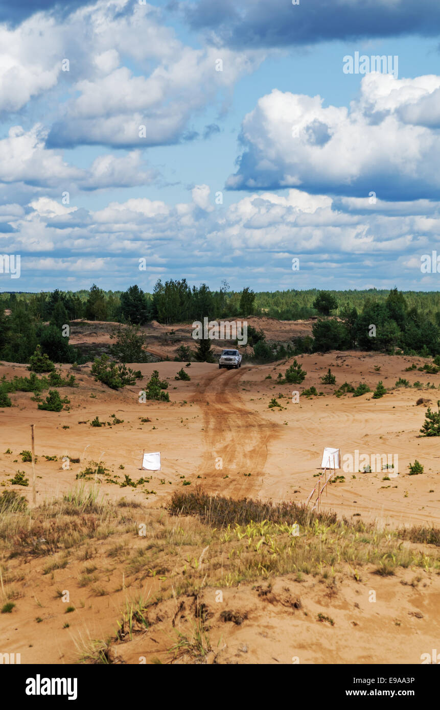 Races on a rally-raid on sandy dunes. Racing car number 222 Stock Photo ...