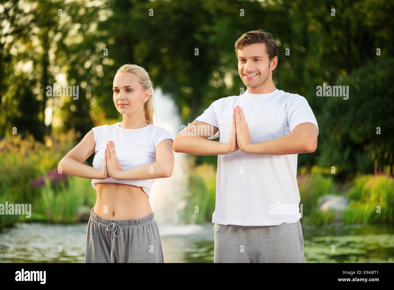 Young couple doing yoga Stock Photo - Alamy