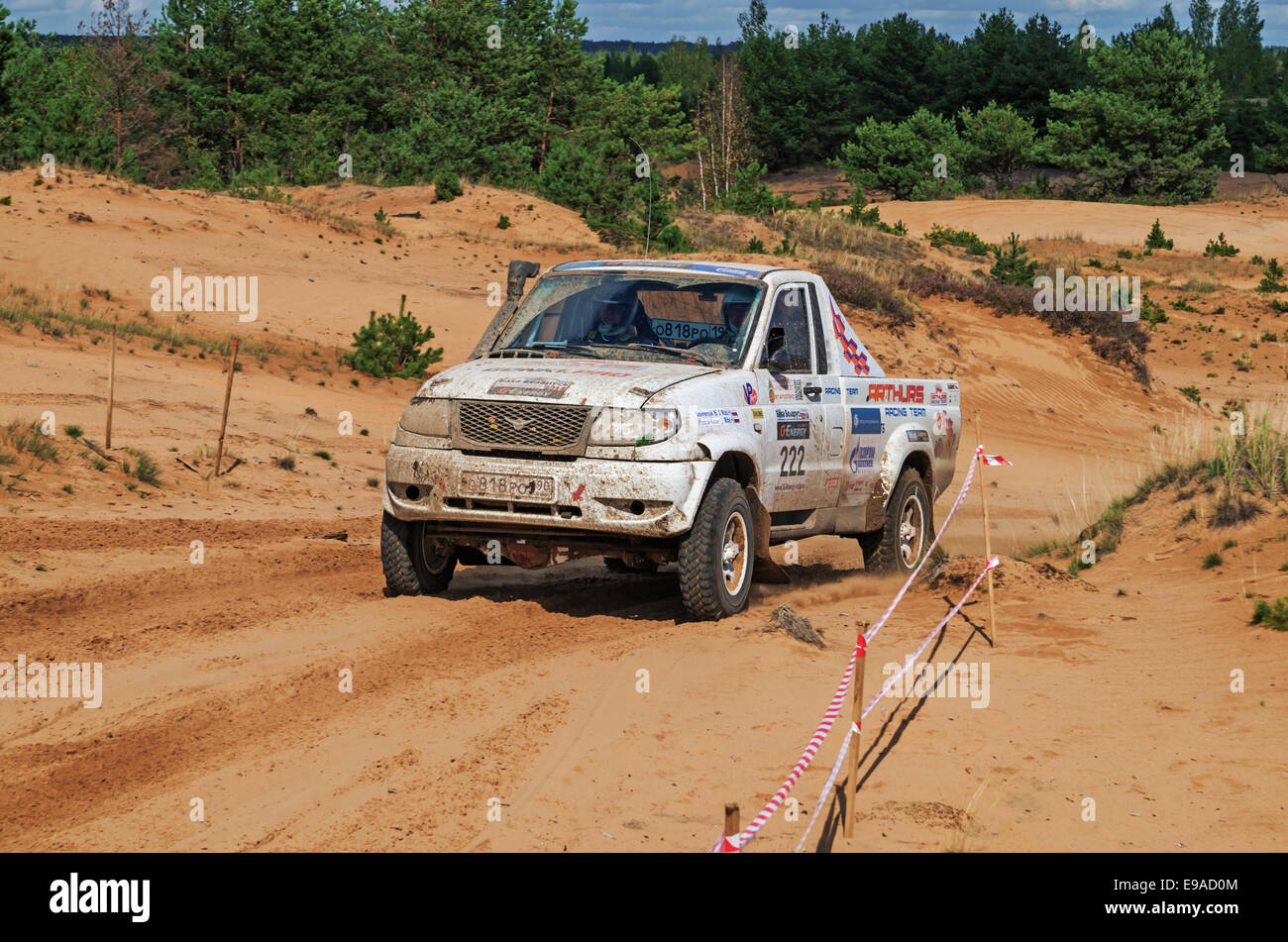 Races on a rally-raid on sandy dunes. Racing car number 222 Stock Photo ...