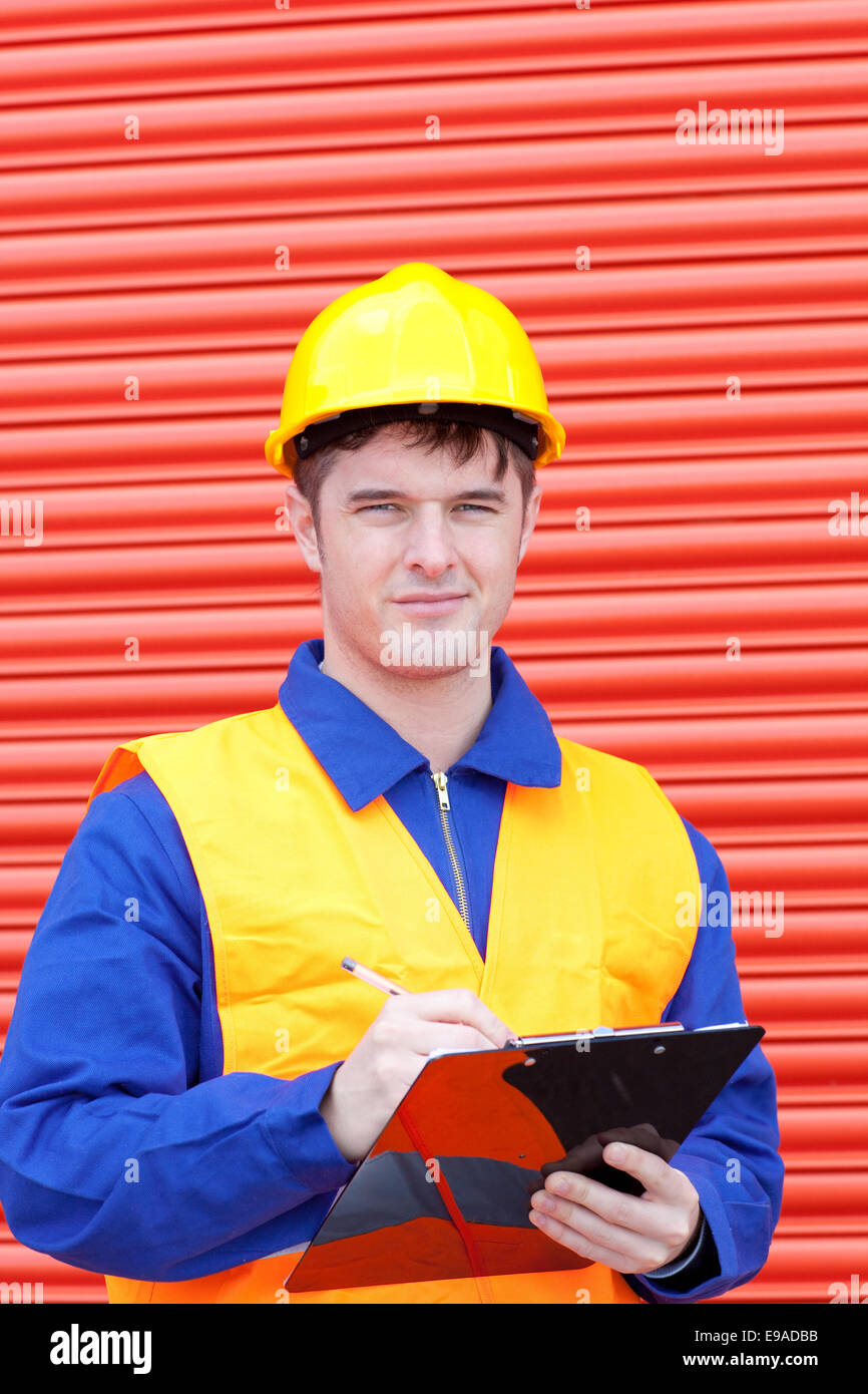 Happy male engineer writing his report Stock Photo - Alamy