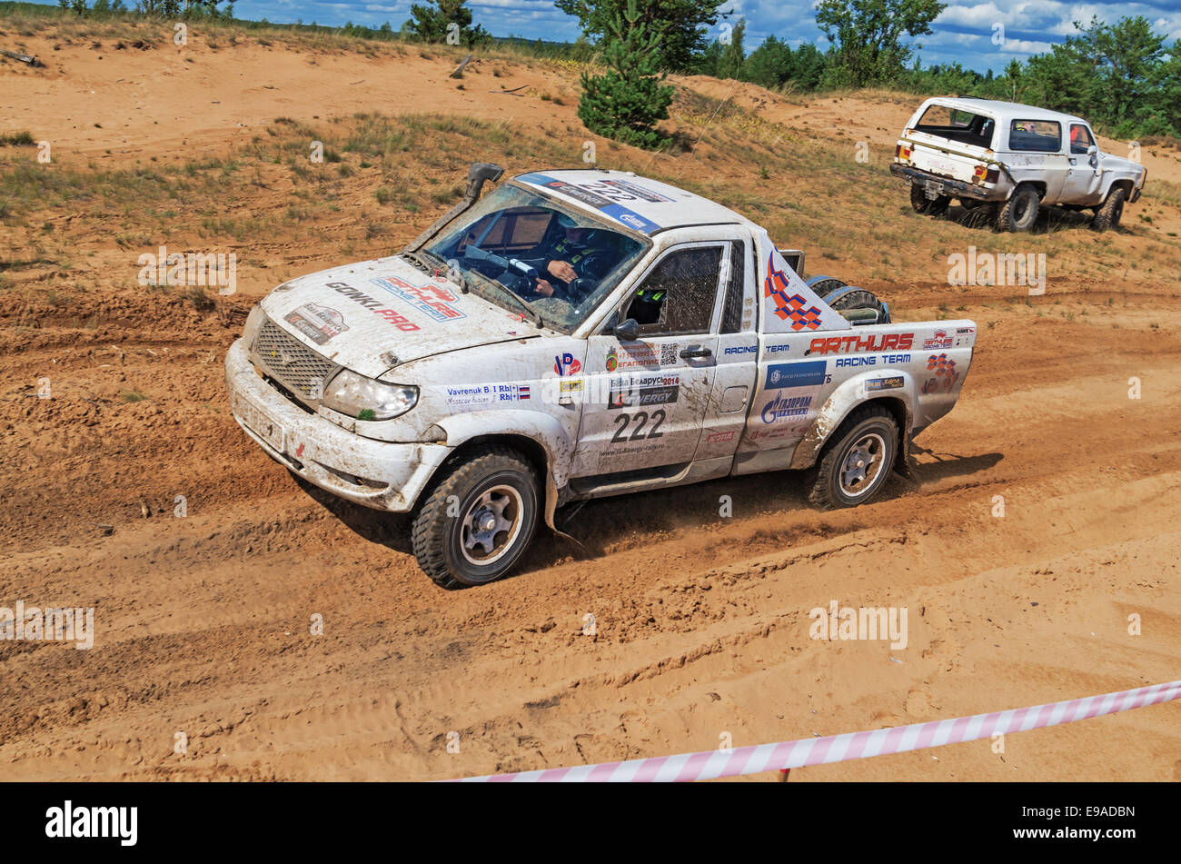 Races on a rally-raid on sandy dunes. Racing car number 222 Stock Photo ...