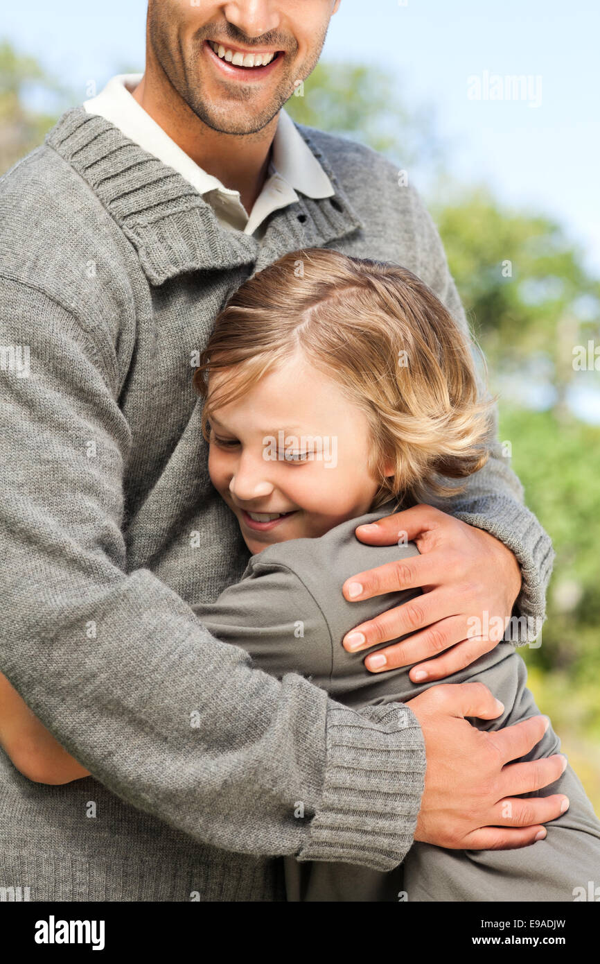 Son embracing his father Stock Photo - Alamy