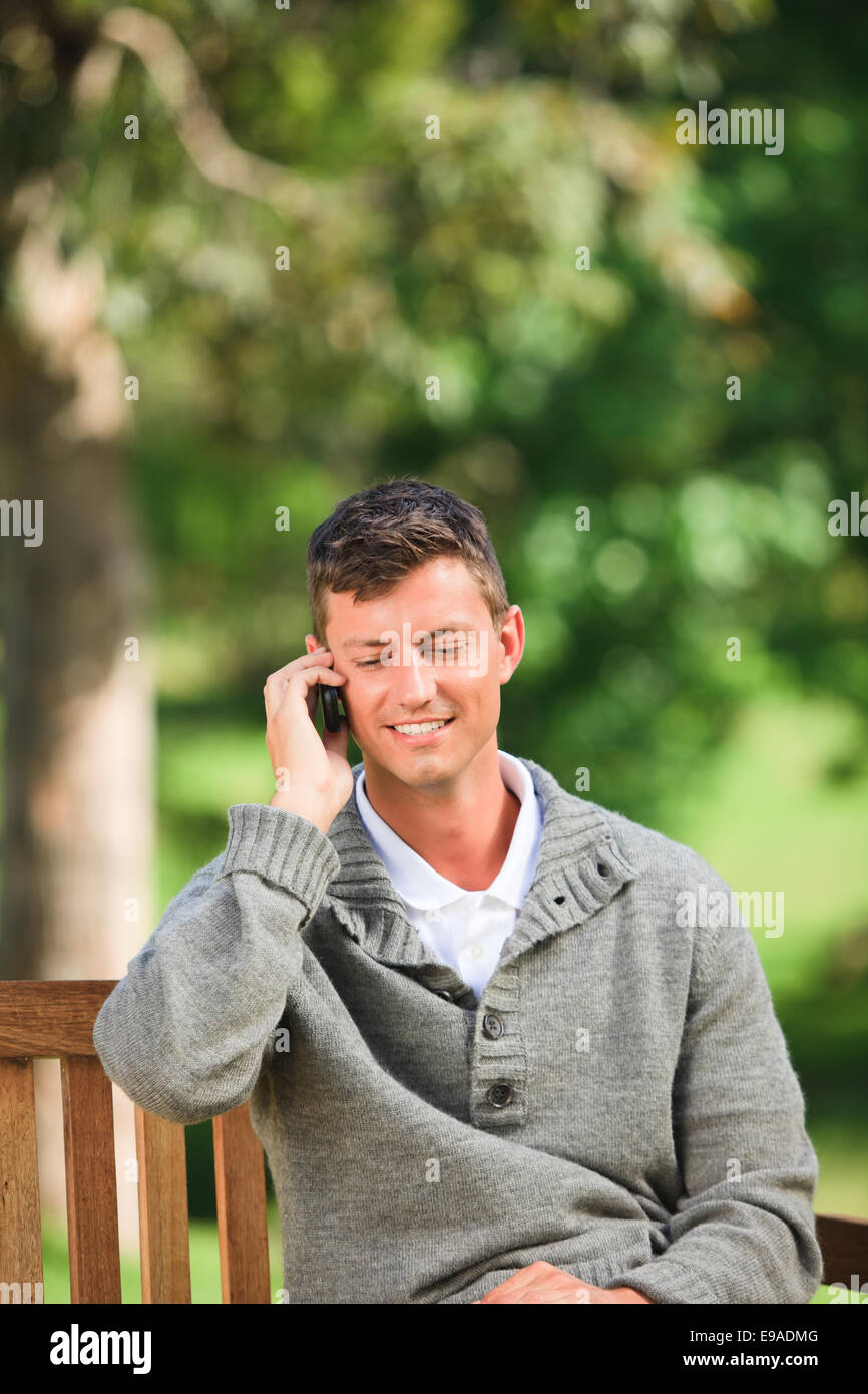 Man phoning on the bench Stock Photo - Alamy