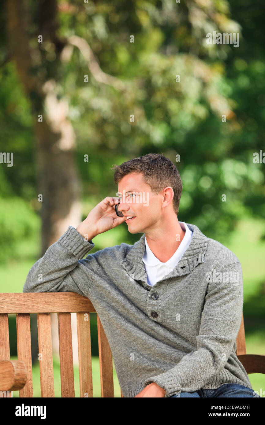 Man phoning on the bench Stock Photo - Alamy