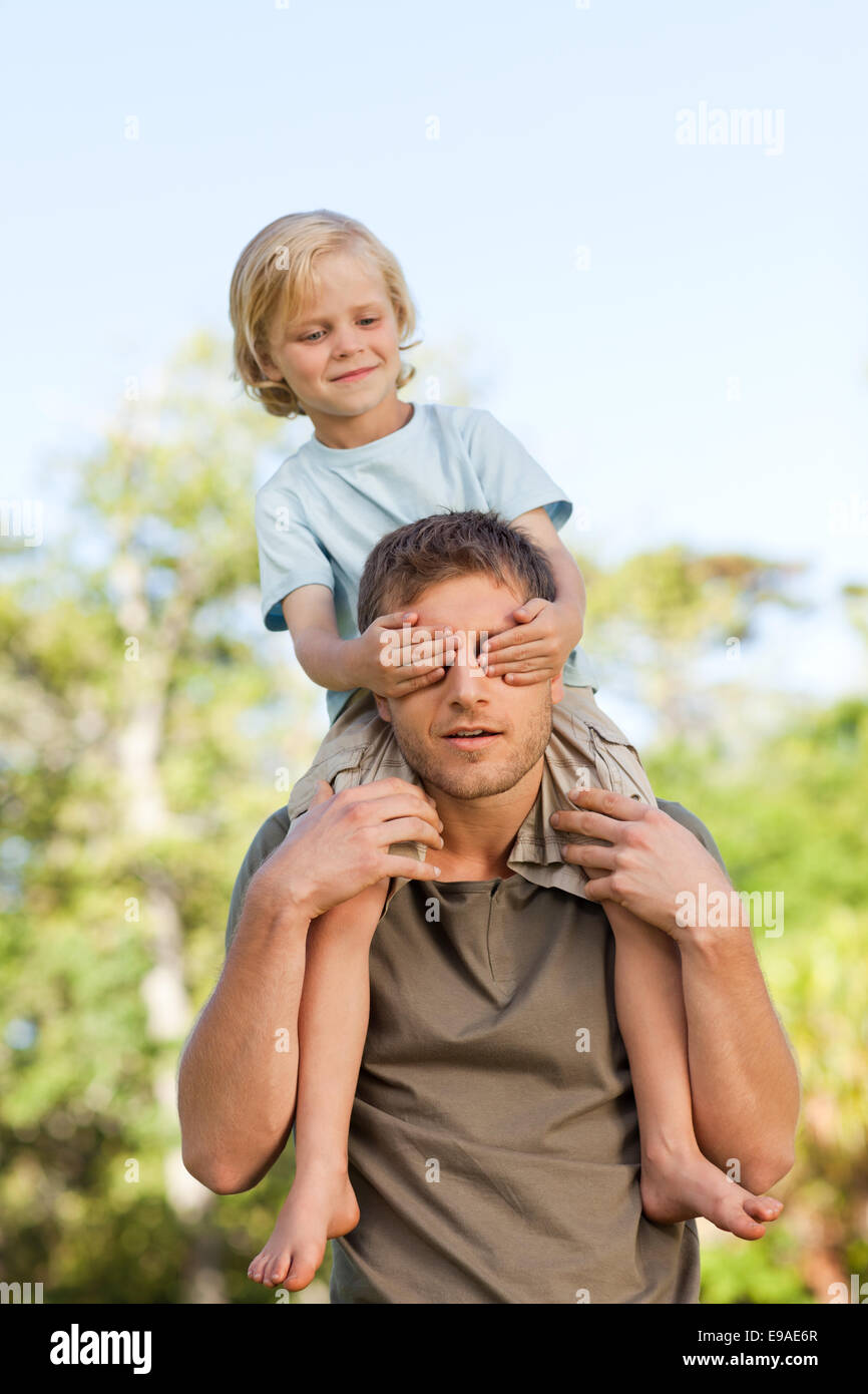 Father giving son a piggyback Stock Photo - Alamy