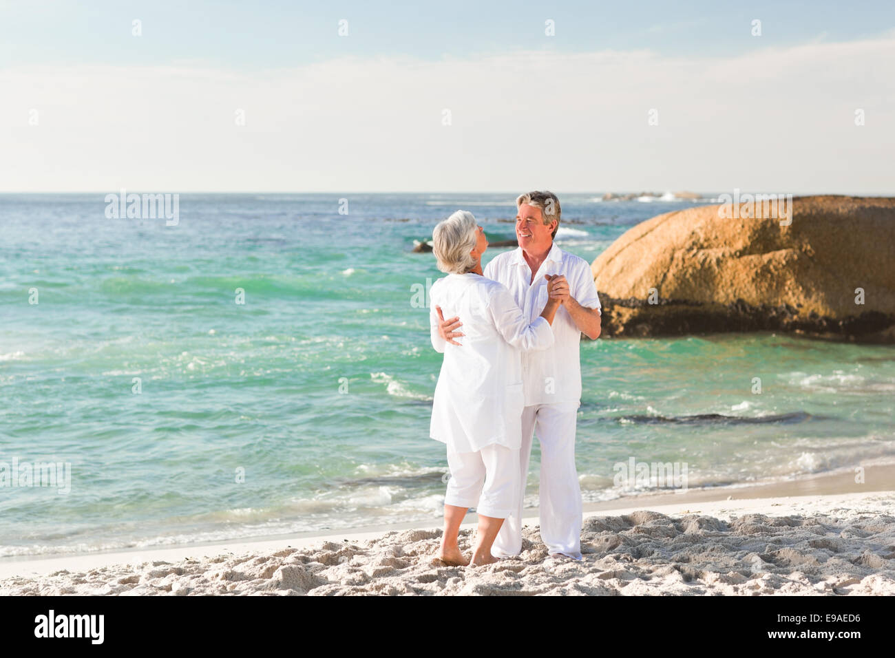 Retired couple dancing on the beach Stock Photo - Alamy