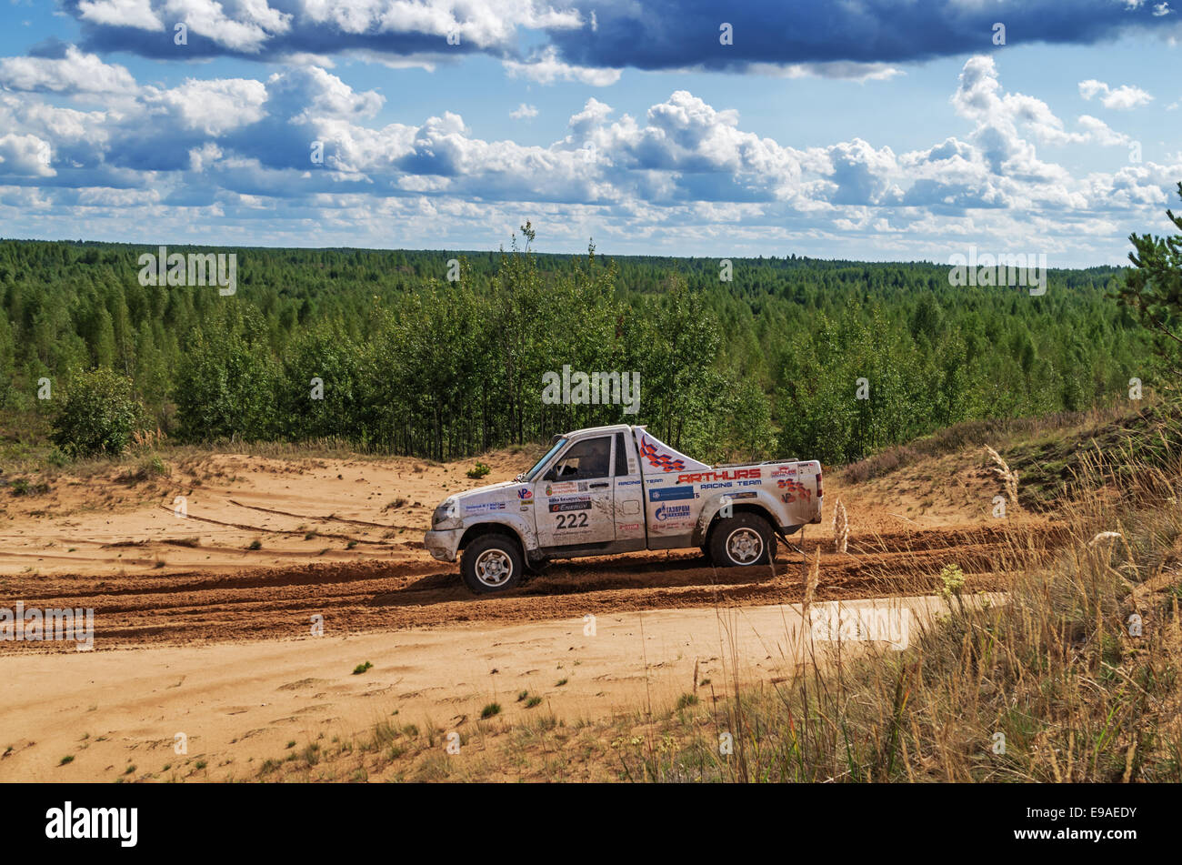 Races on a rally-raid on sandy dunes. Racing car number 222 Stock Photo ...