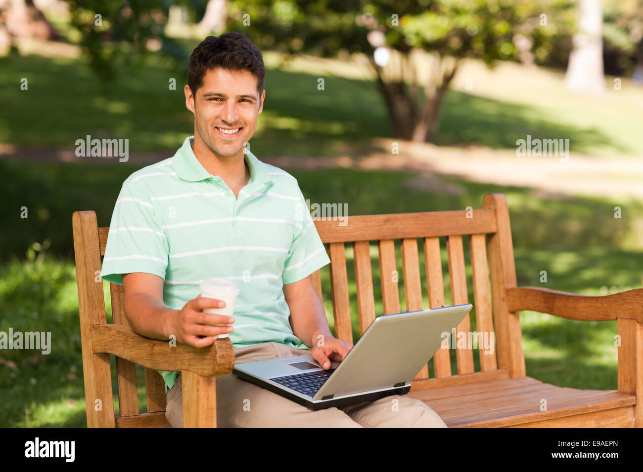 Handsome man working on his laptop Stock Photo - Alamy
