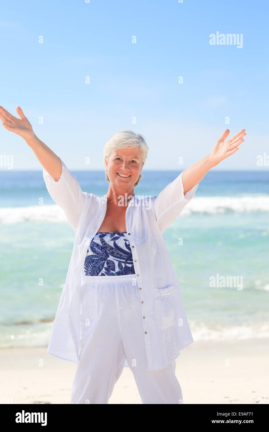 Happy retired woman on the beach Stock Photo - Alamy