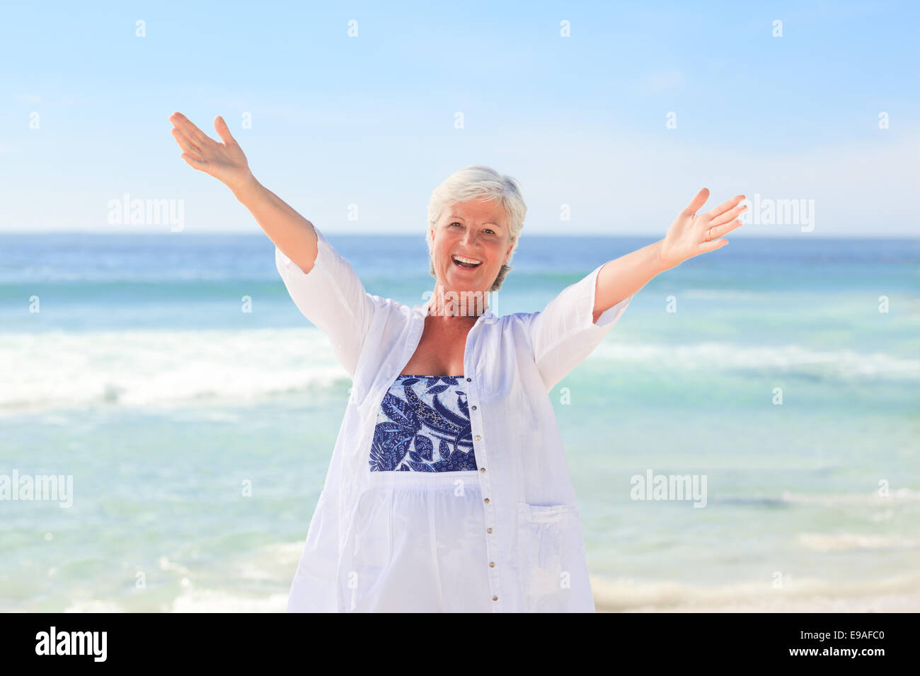 Happy retired woman on the beach Stock Photo - Alamy