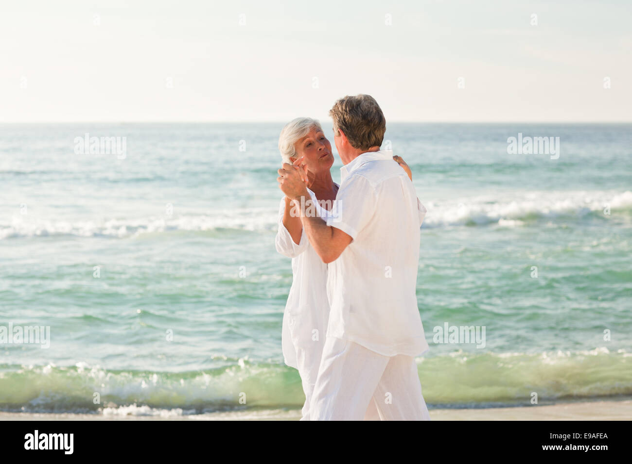Retired couple dancing on the beach Stock Photo - Alamy