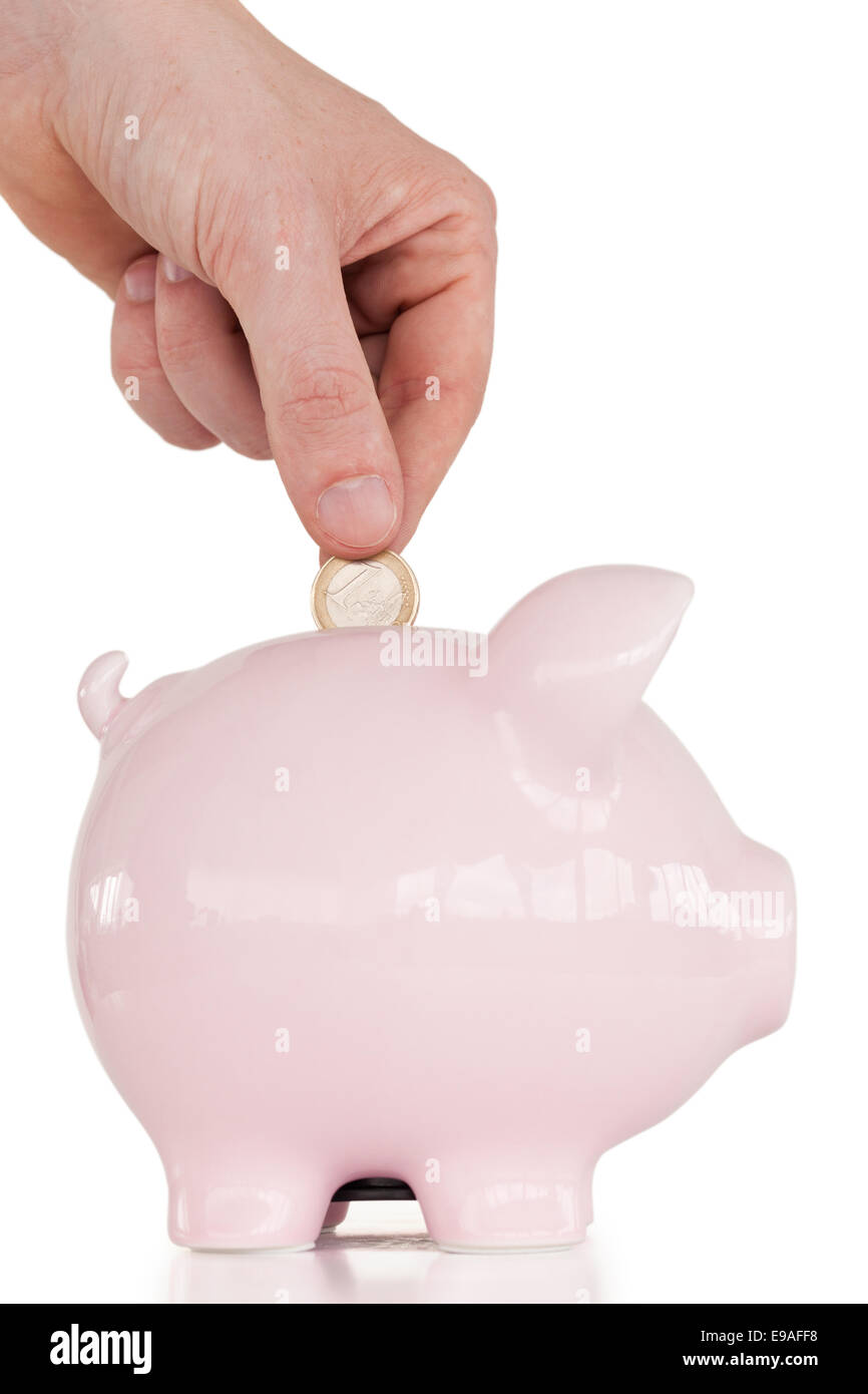 Inserting coin in piggy bank hi-res stock photography and images - Alamy