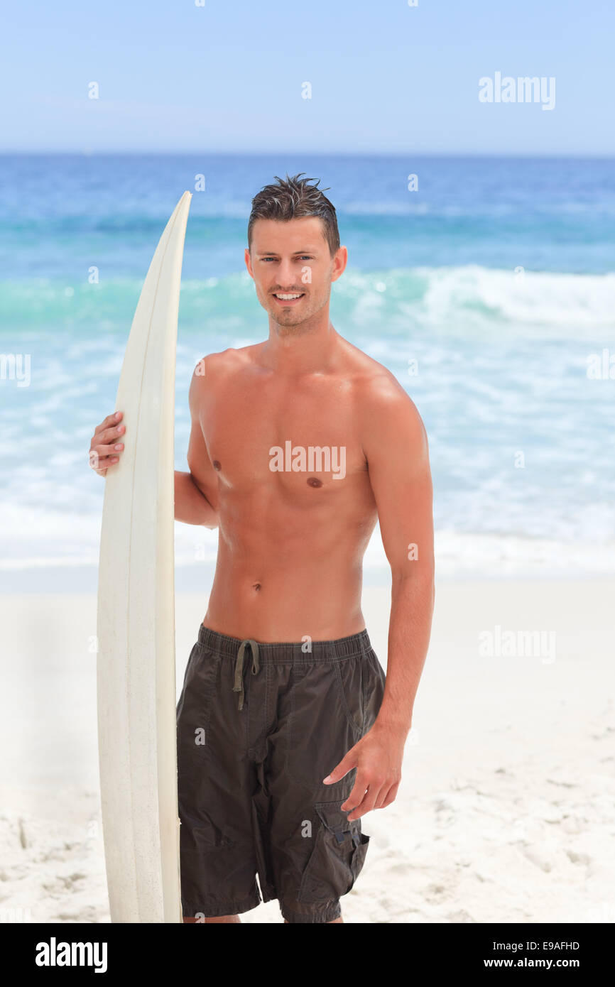 Man posing with his surfboard Stock Photo - Alamy