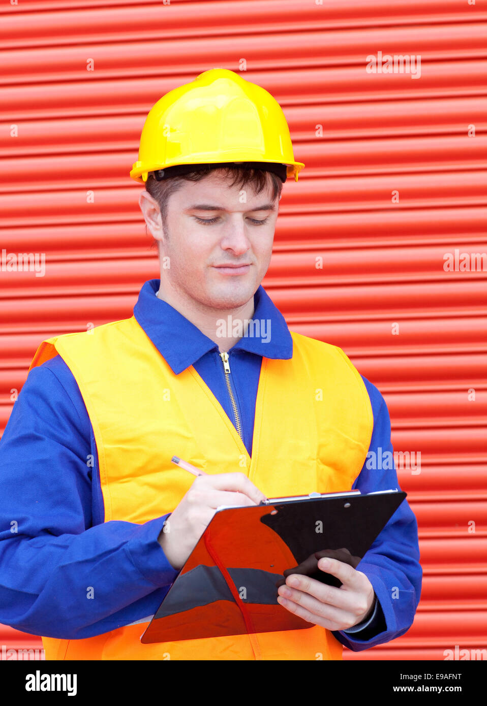Serious male engineer writing his report Stock Photo - Alamy