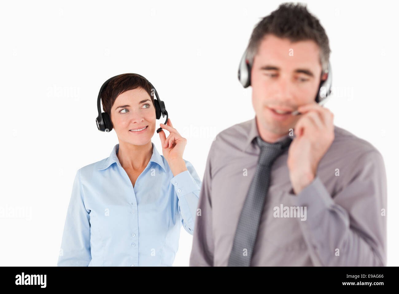 Business people speaking through headsets Stock Photo - Alamy