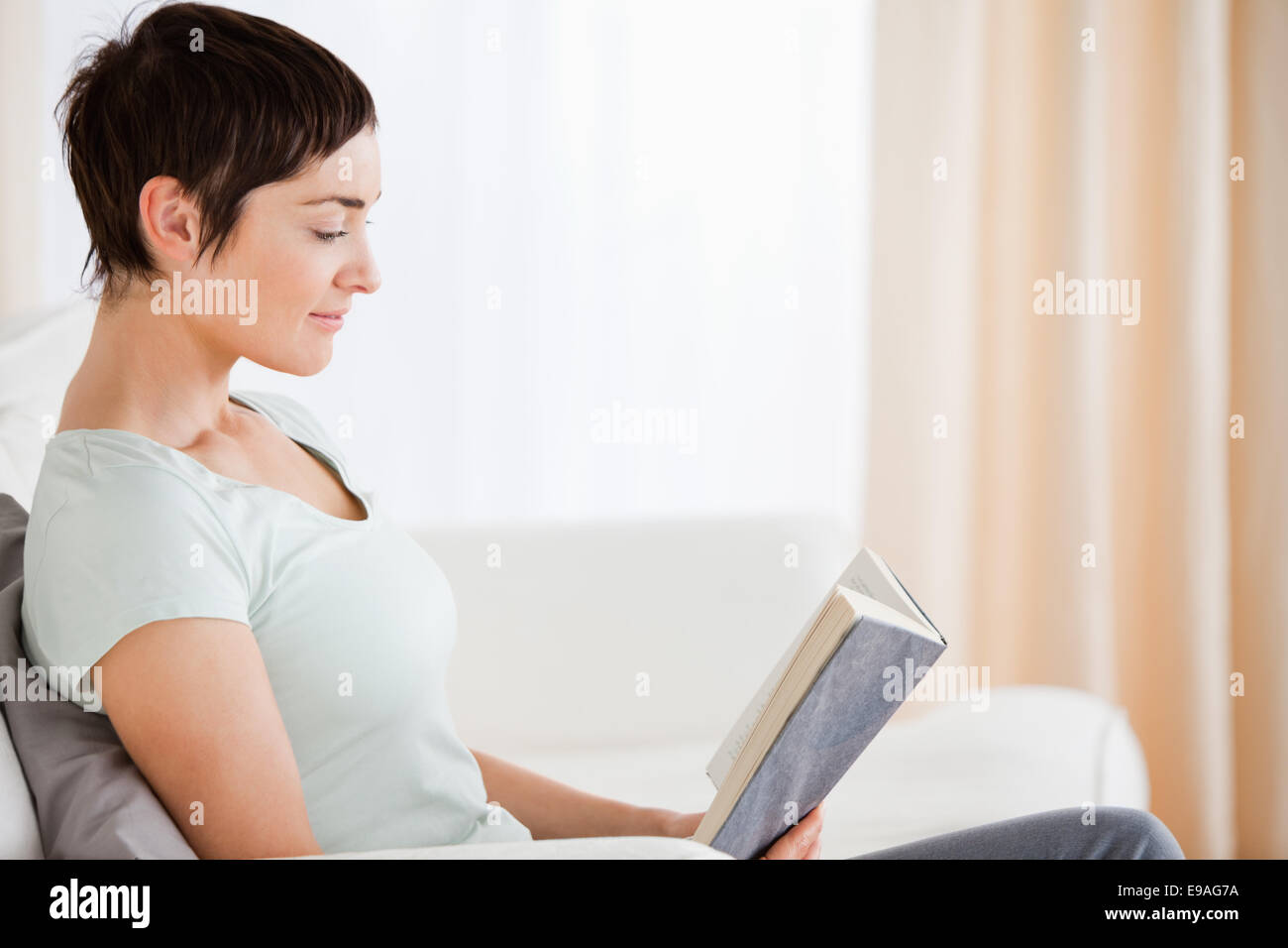 Short-haired woman reading a book Stock Photo - Alamy