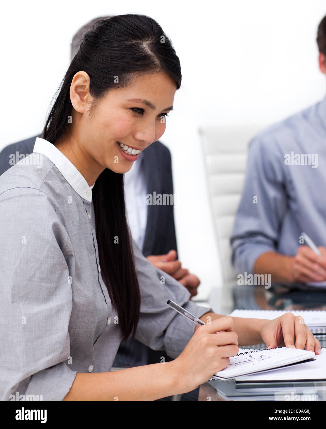 Happy female executive studying a document Stock Photo - Alamy