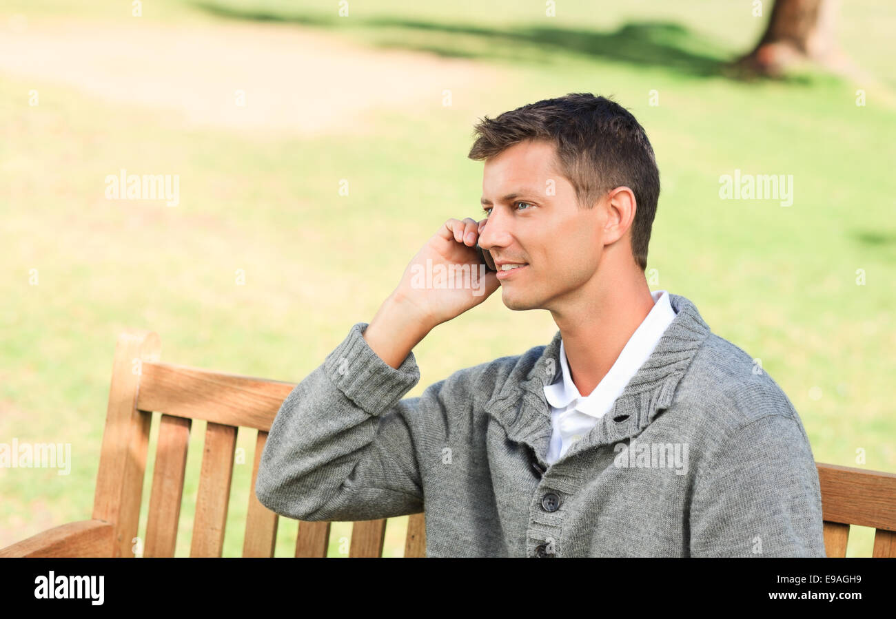 Man phoning on the bench Stock Photo - Alamy