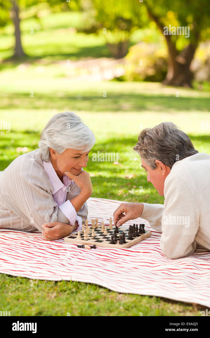 Elderly couple playing chess Stock Photo - Alamy