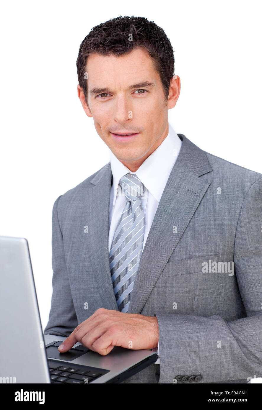 Charismatic young businessman using a laptop Stock Photo - Alamy