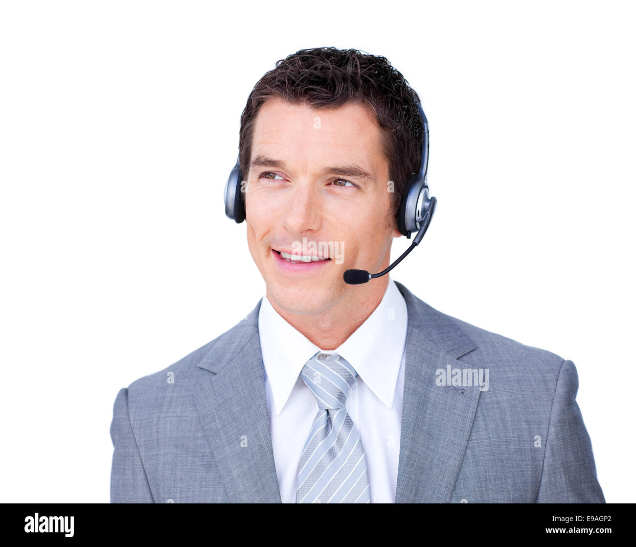Smiling attractive businessman using headset Stock Photo - Alamy