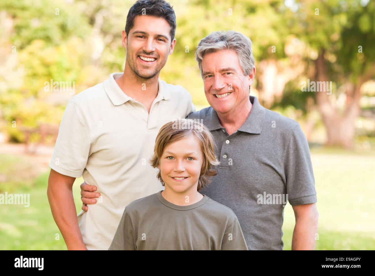 Family looking at the camera in the park Stock Photo - Alamy