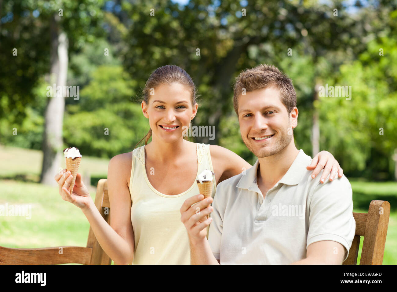 Couple eating an ice cream in the park Stock Photo - Alamy