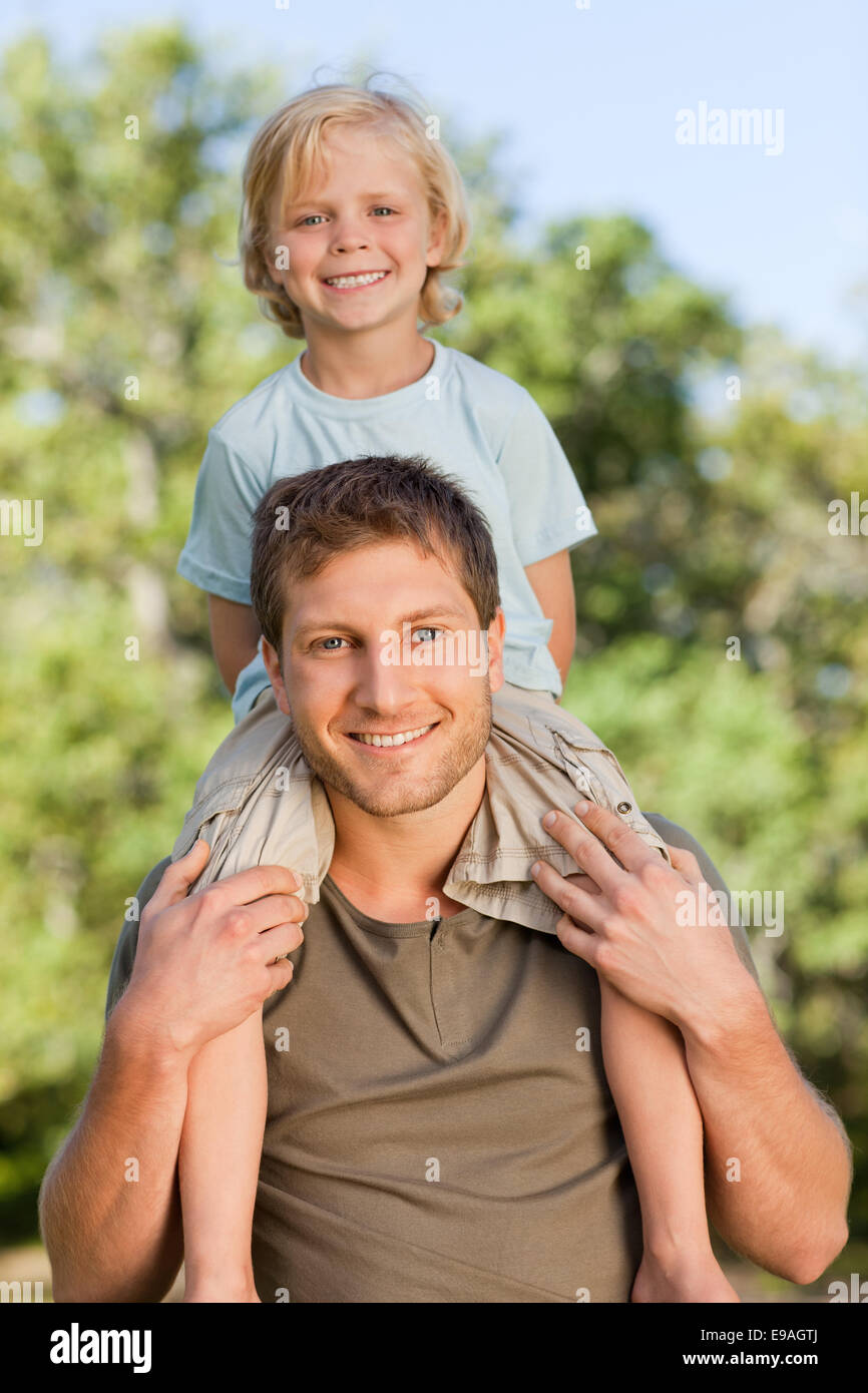Father giving son a piggyback Stock Photo - Alamy