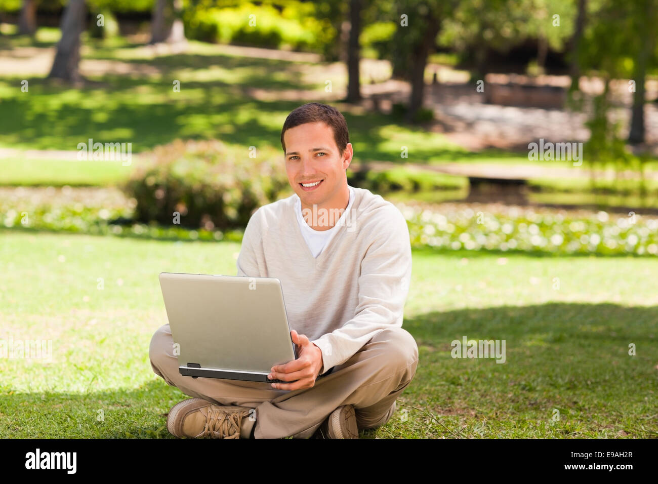 Man working on his laptop in the park Stock Photo - Alamy