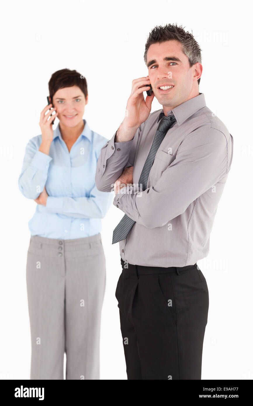 Portrait of coworkers making a phone call Stock Photo - Alamy