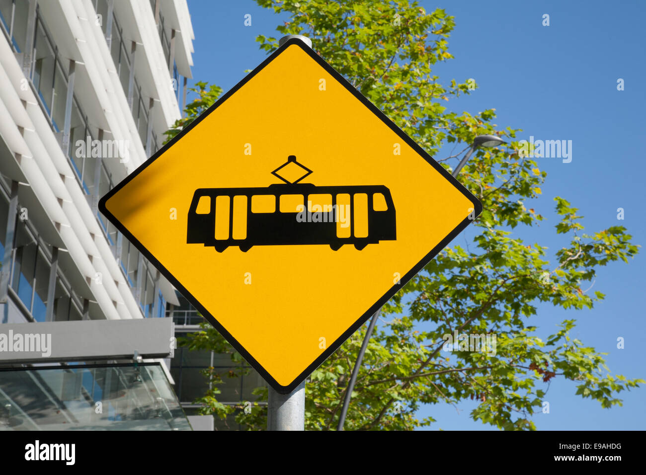 Yellow Tram Sign in Urban Setting Stock Photo - Alamy