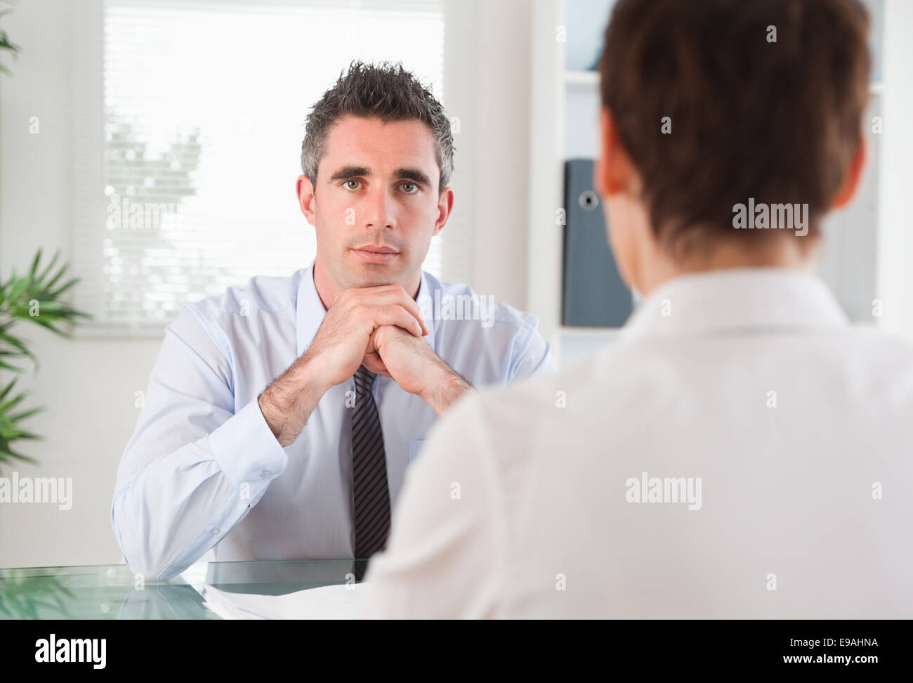 Handsome manager interviewing an applicant Stock Photo - Alamy