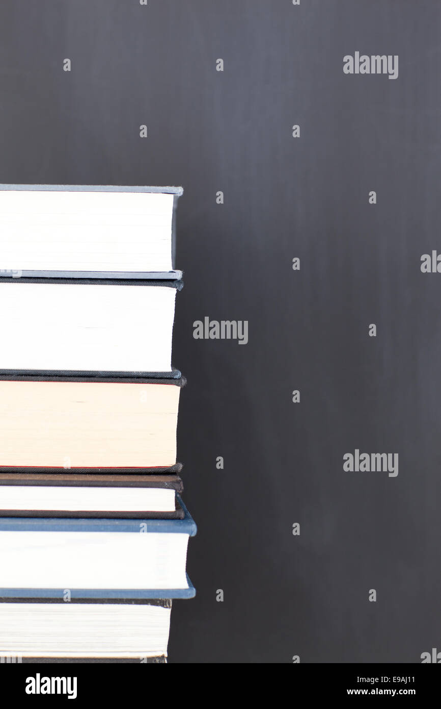 Stack of books and a clean blackboard Stock Photo - Alamy